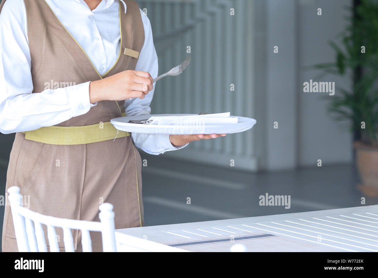 Waitress against empty tableware, table setting. close up Stock Photo ...