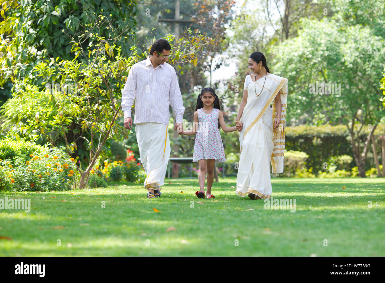 South Indian family walking together in a park Stock Photo - Alamy