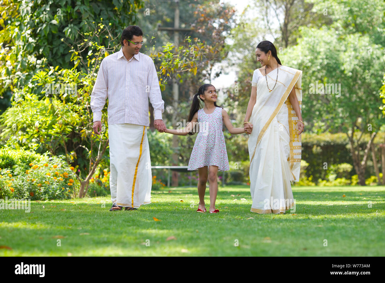 South Indian family walking together in a park Stock Photo - Alamy