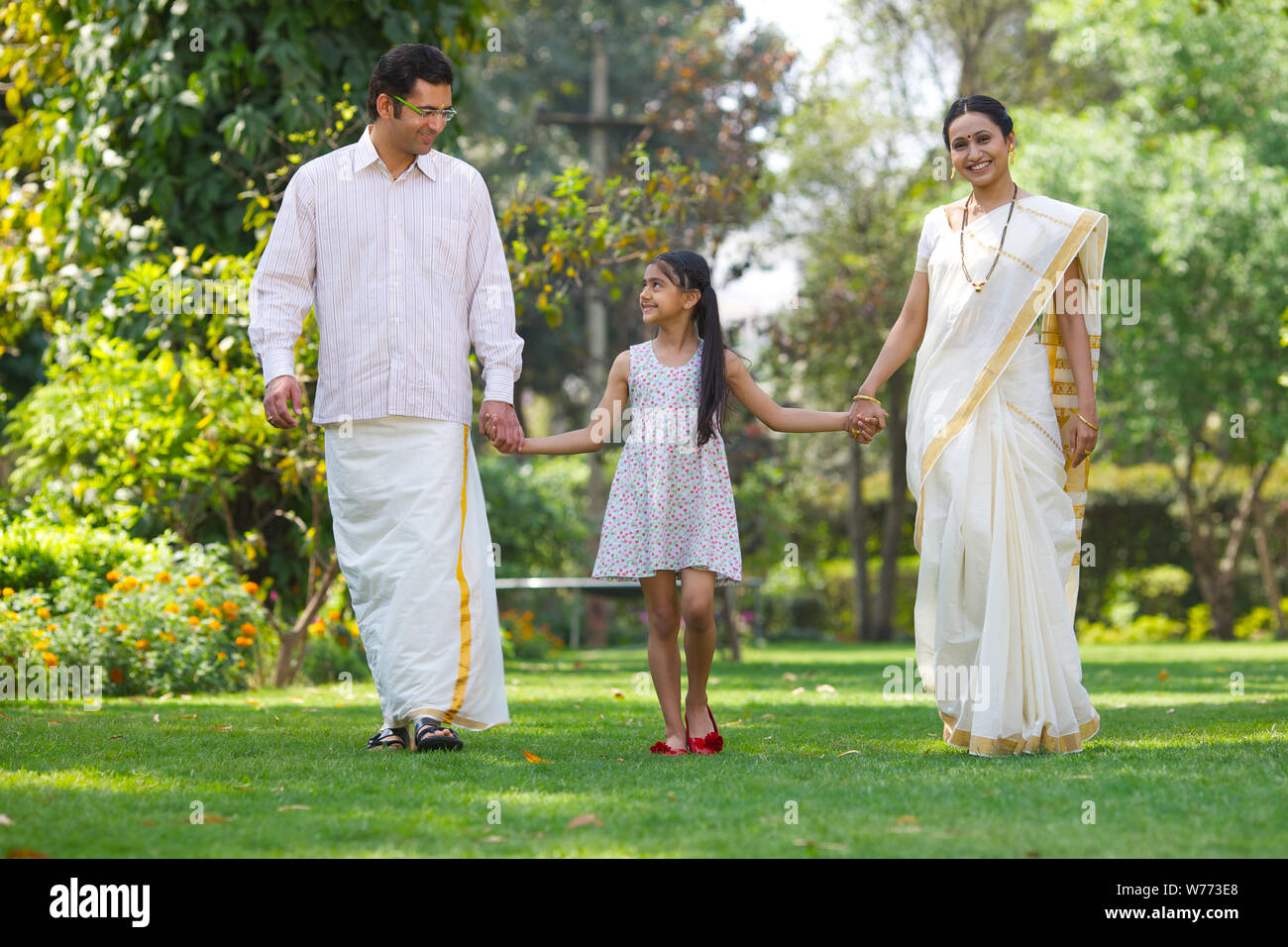 South Indian family walking together in a park Stock Photo - Alamy