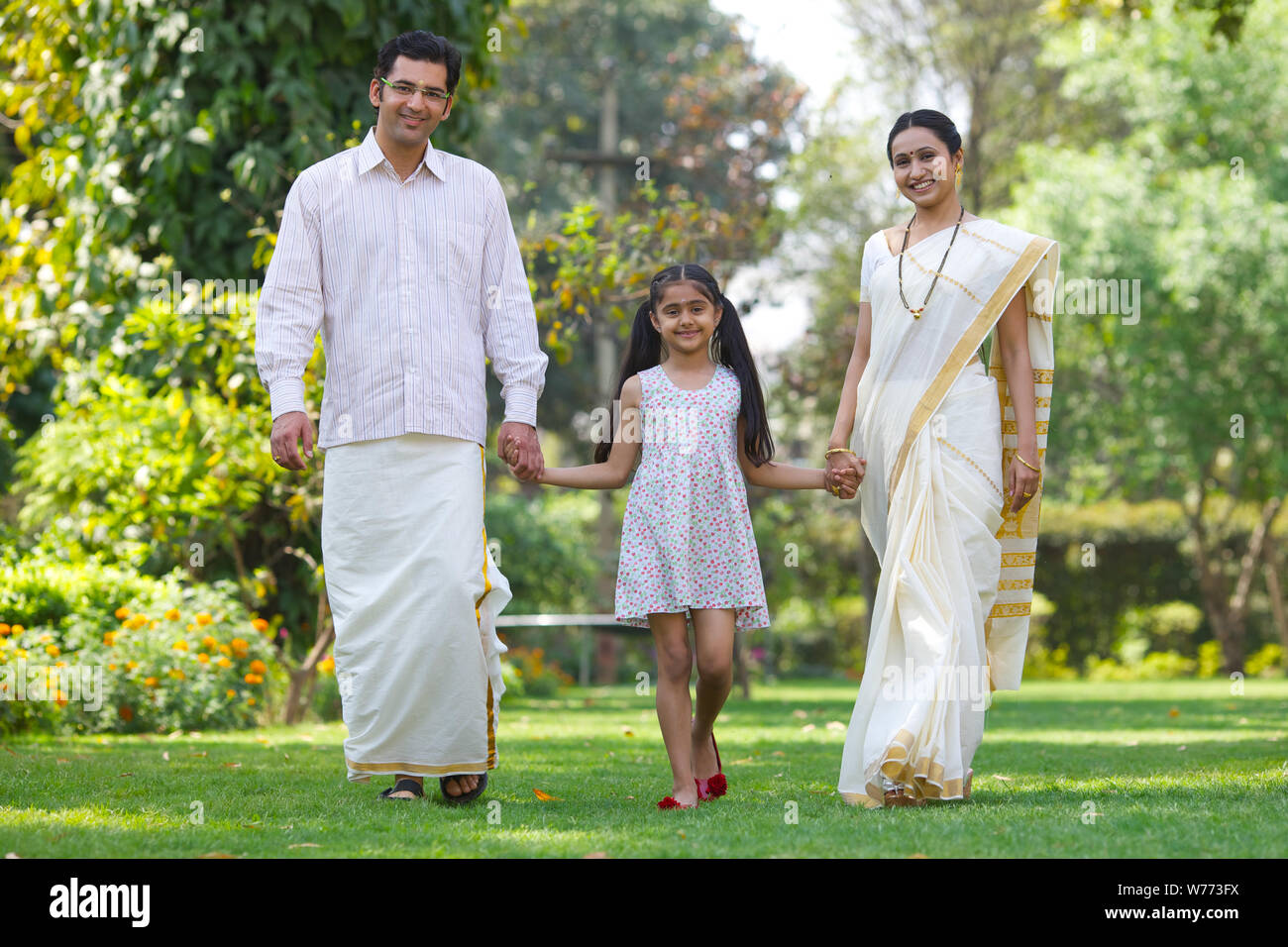South Indian family walking together in a park Stock Photo - Alamy