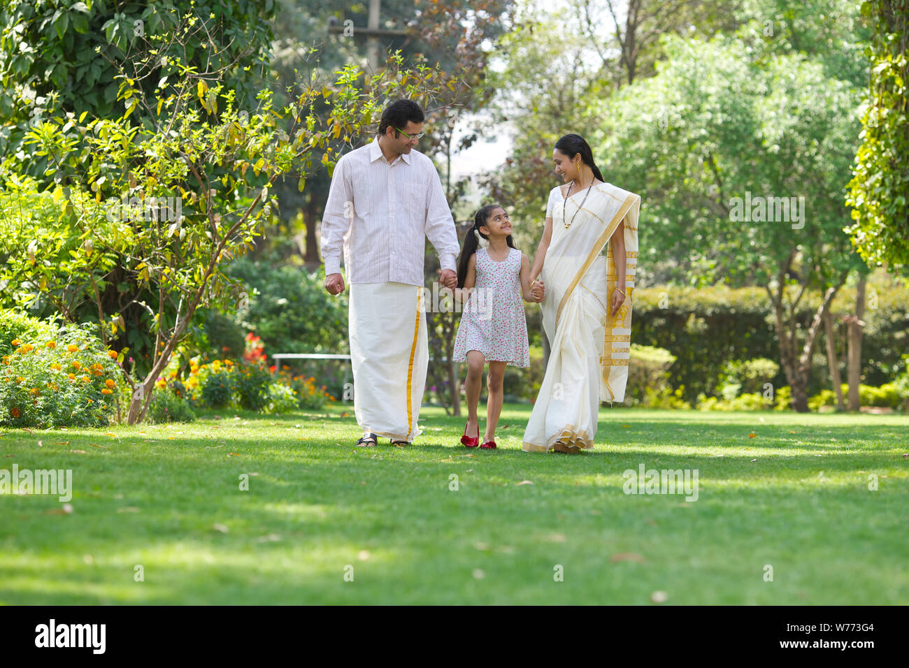 South Indian family walking together in a park Stock Photo - Alamy