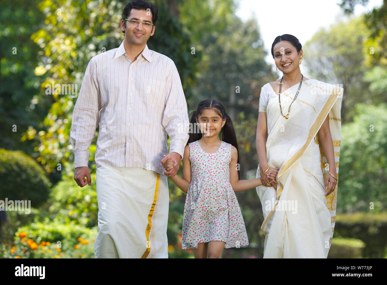 South Indian family walking together in a park Stock Photo - Alamy