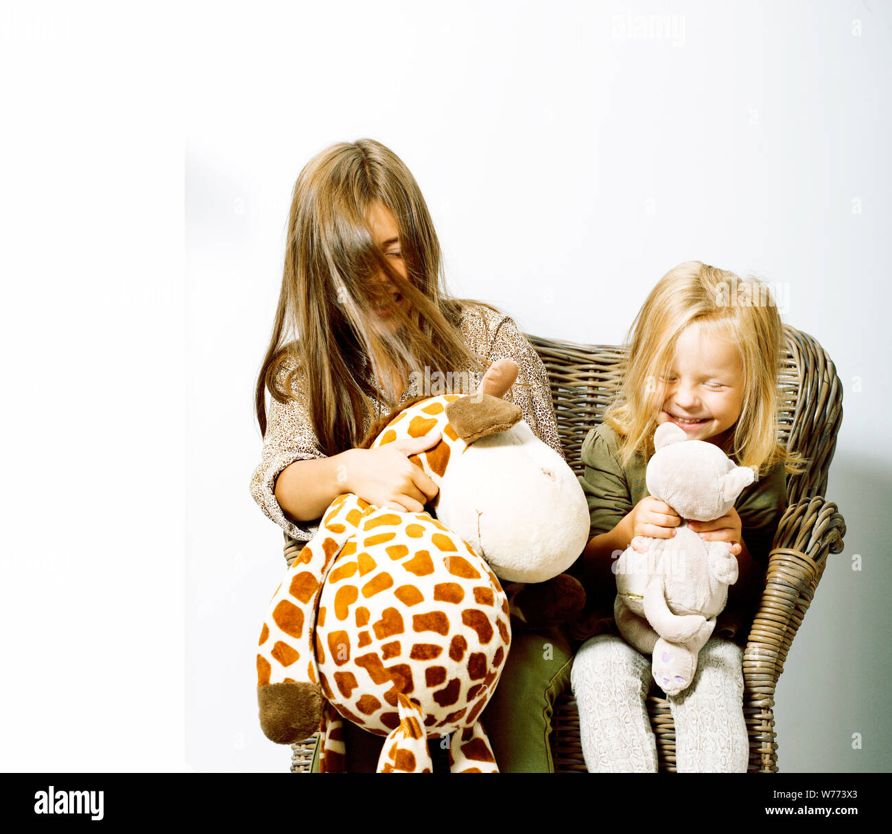 two cute sisters at home interior playing, little happy smiling girl in ...