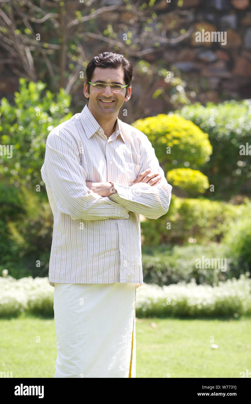 South Indian man standing with arms crossed Stock Photo - Alamy