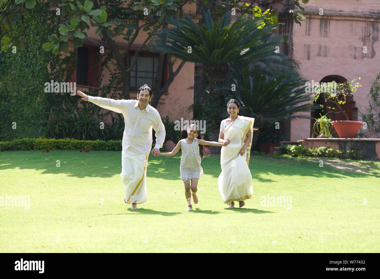 South Indian family playing in a lawn Stock Photo - Alamy