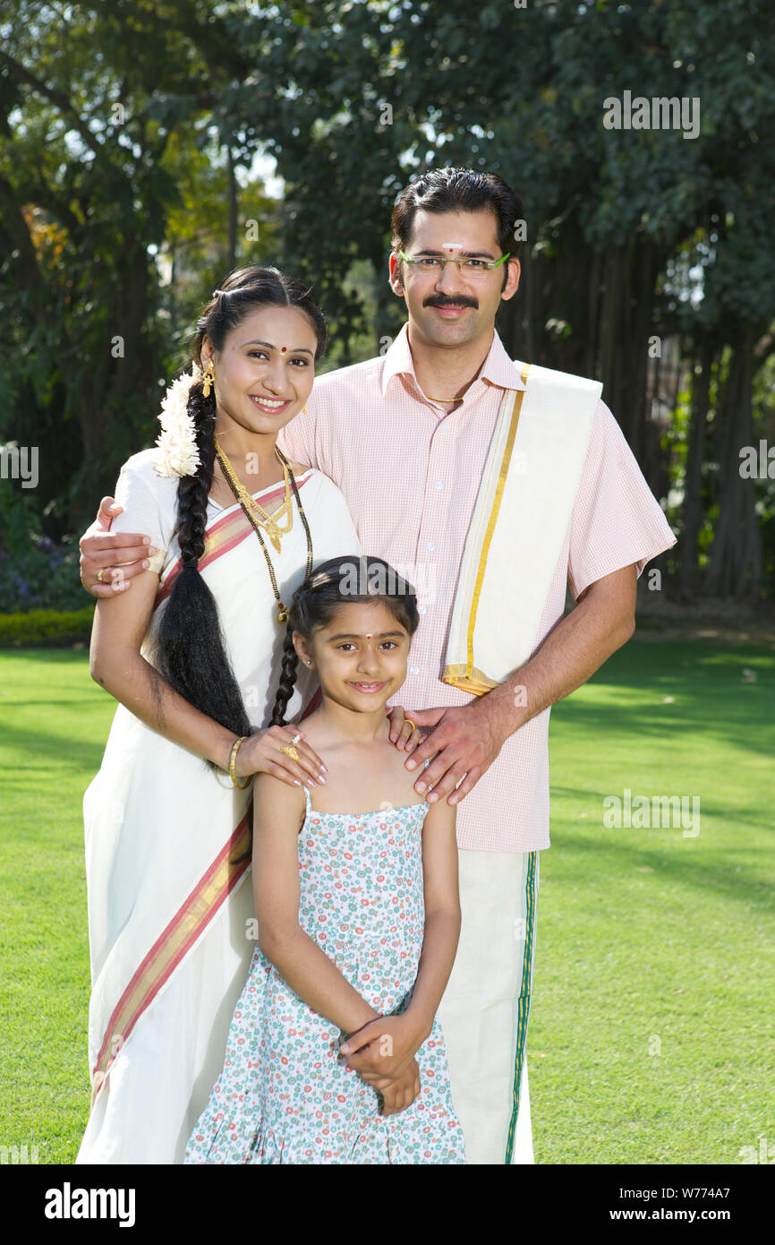 South Indian family standing together in a lawn Stock Photo - Alamy