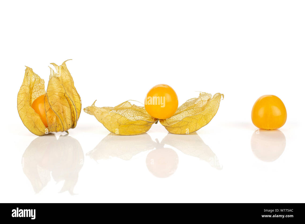 Group of three whole fresh orange physalis in row isolated on white ...