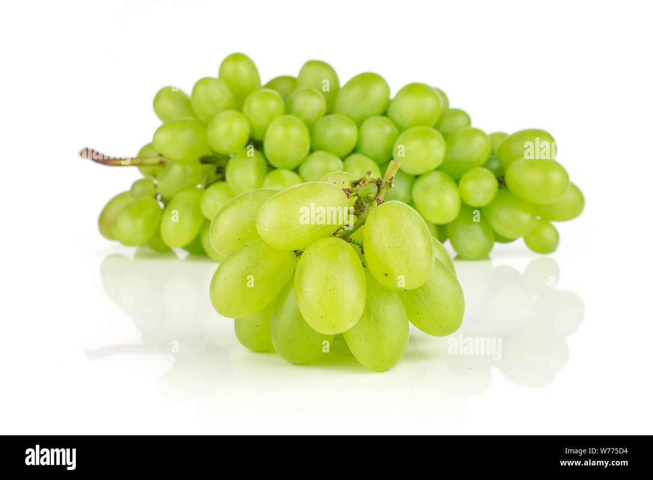 Lot of whole fresh green grape small bunch is in the front isolated on ...