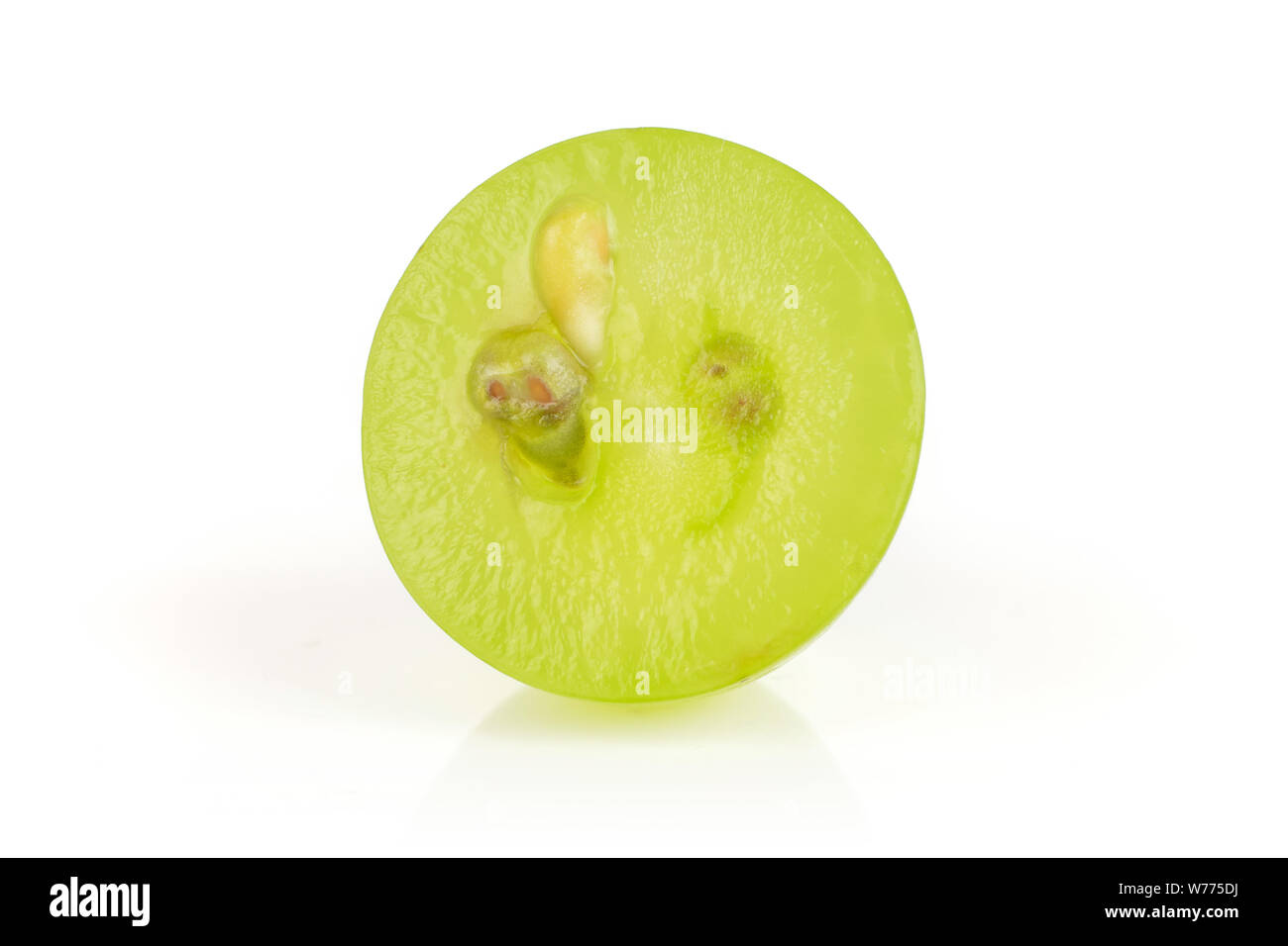 One half of fresh green grape with seed isolated on white background ...