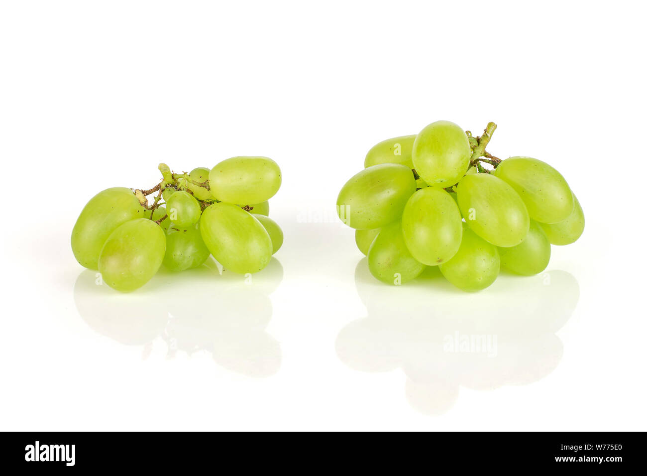 Two small bunches of fresh green grape isolated on white background ...