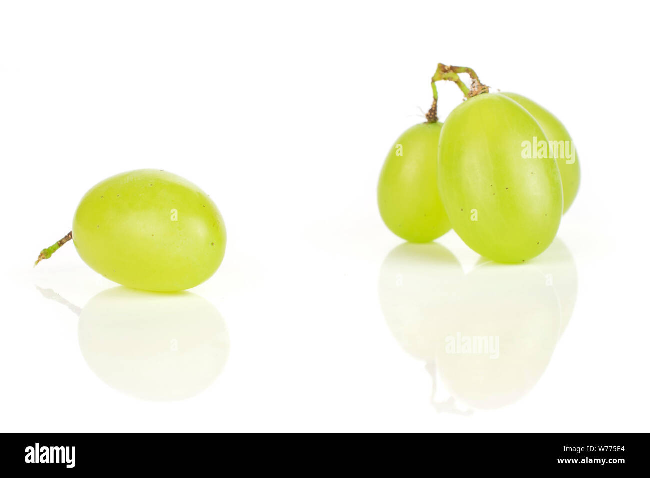 Group of four whole fresh green grape isolated on white background ...