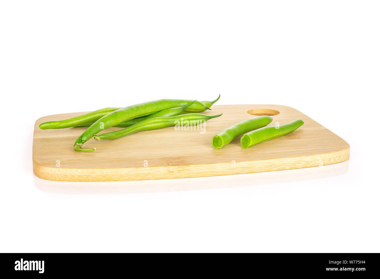 Group of lot of whole two halves of fresh green bean on bamboo cutting ...