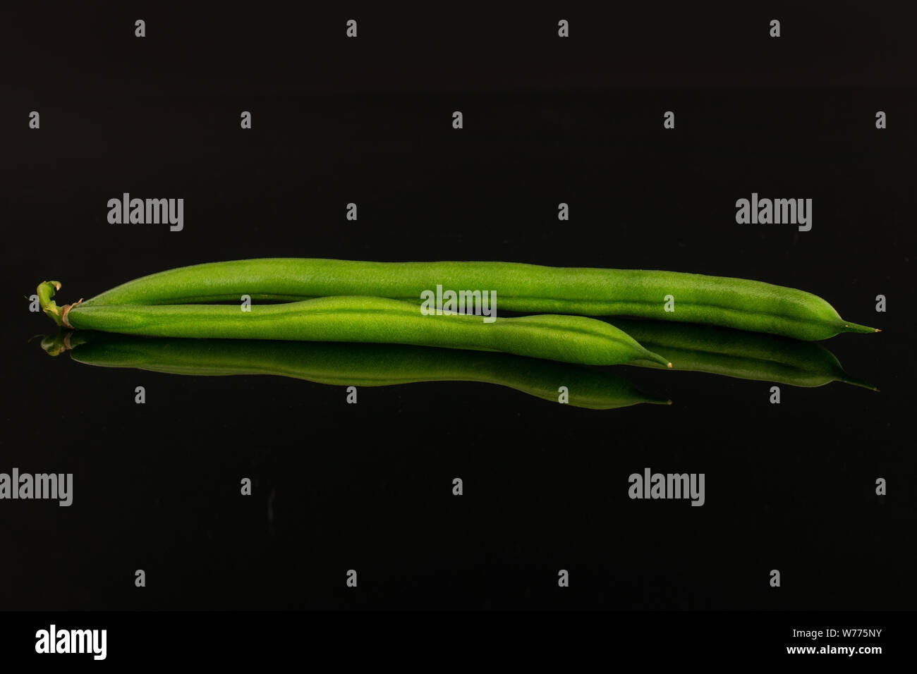Group of two whole fresh green bean isolated on black glass Stock Photo ...