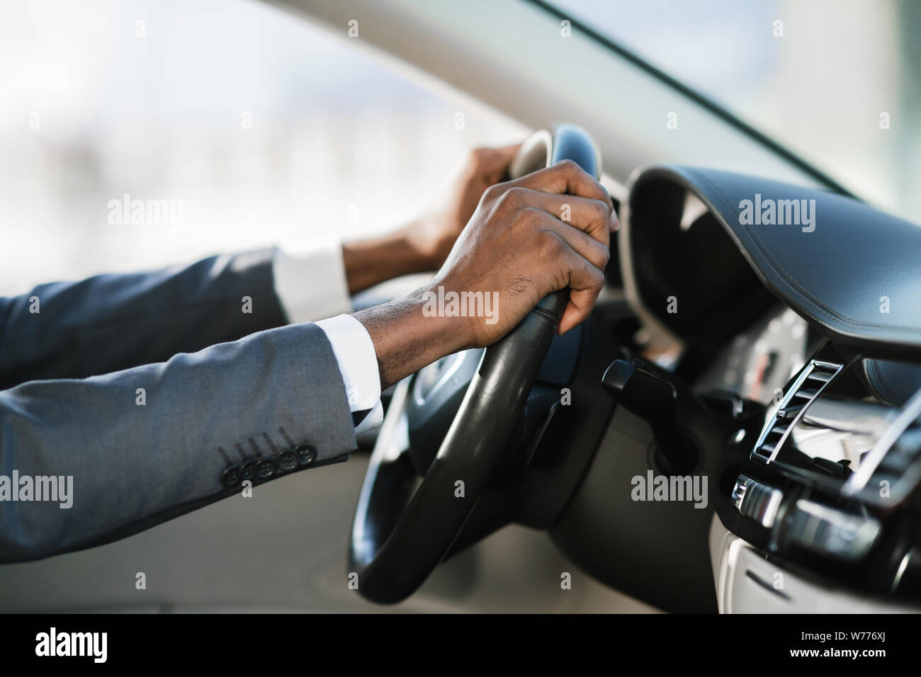 Businessman driving car on highway, holding hands on wheel Stock Photo ...