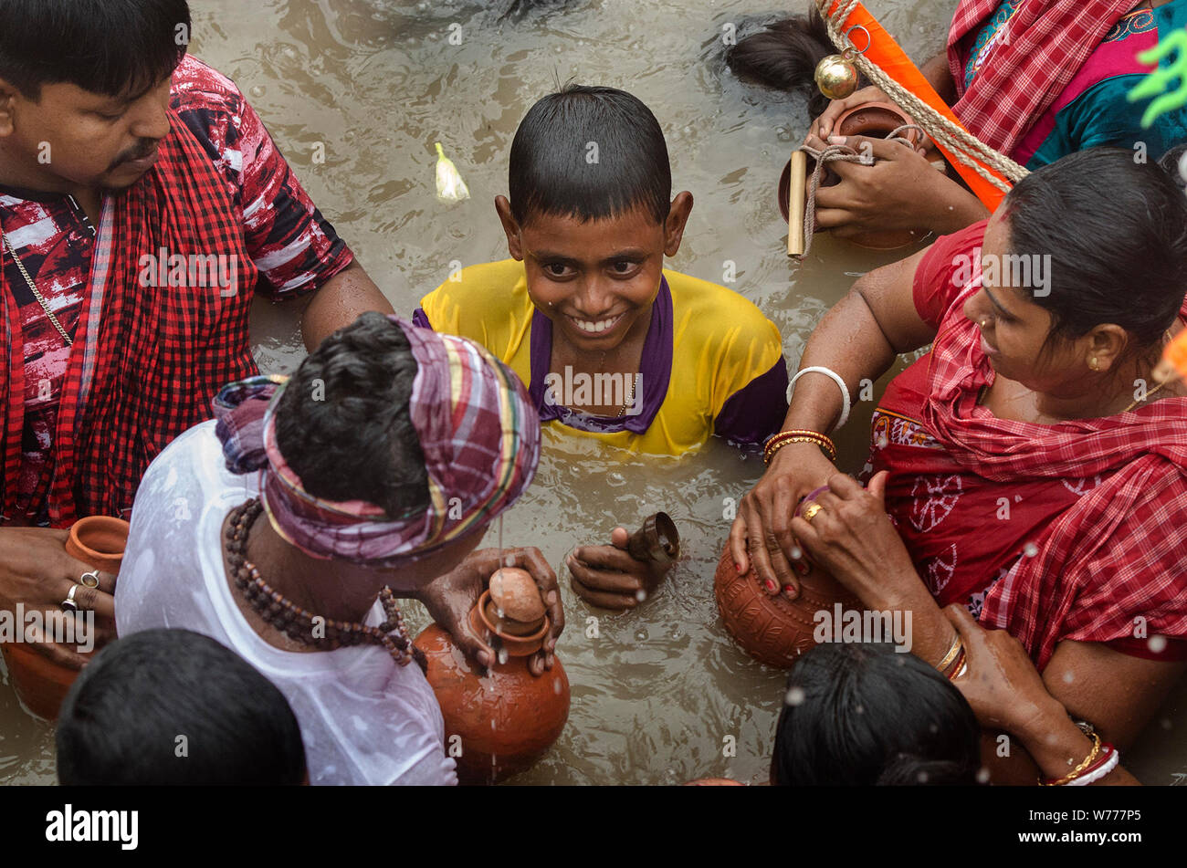 Kolkata, India. 4th Aug, 2019. Hindu devotees collect holy water from ...