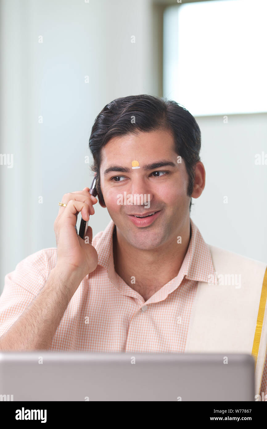 South Indian man talking on a mobile phone Stock Photo - Alamy