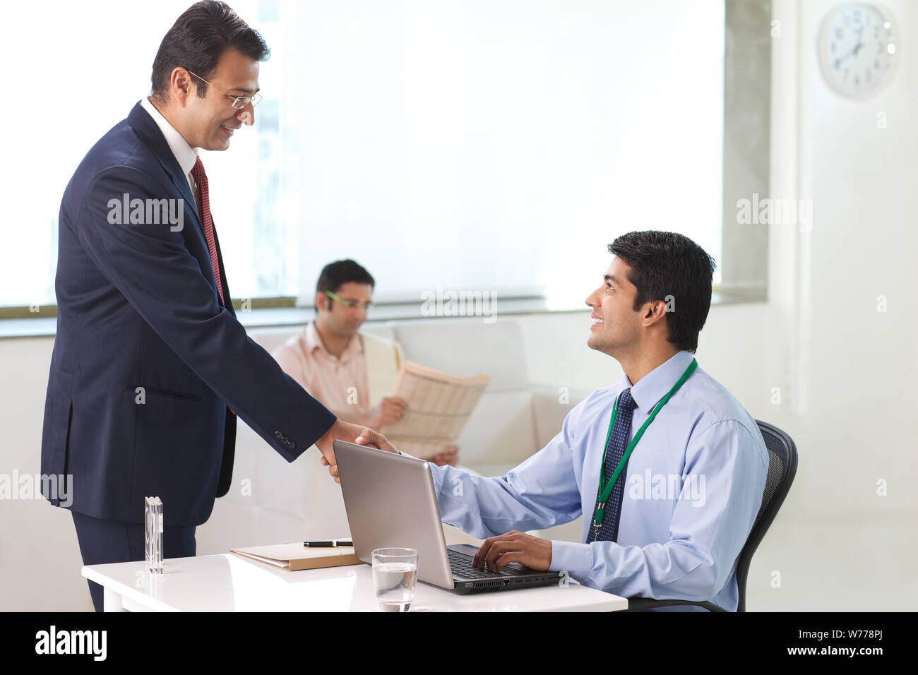 Financial advisor shaking hands with his customer Stock Photo - Alamy