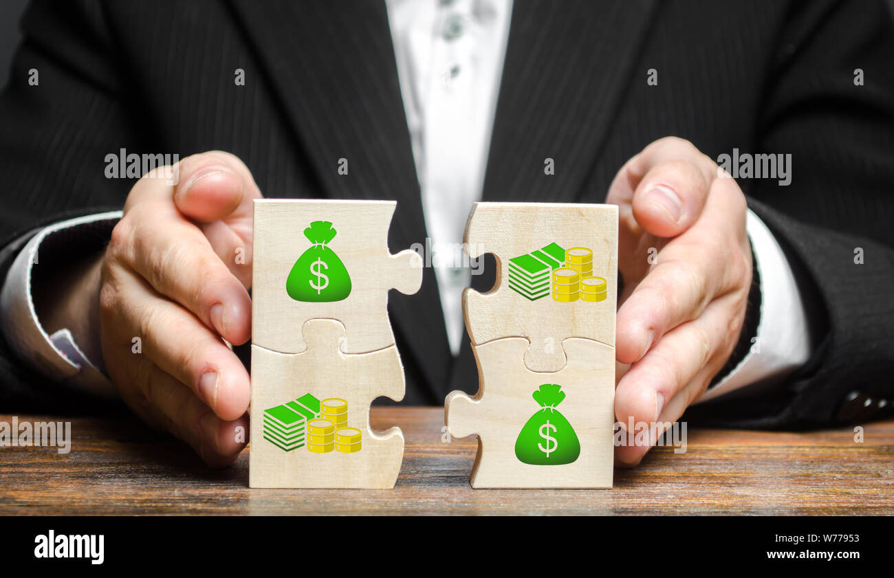 Businessman combines money puzzles. Fundraising, attracting investments ...