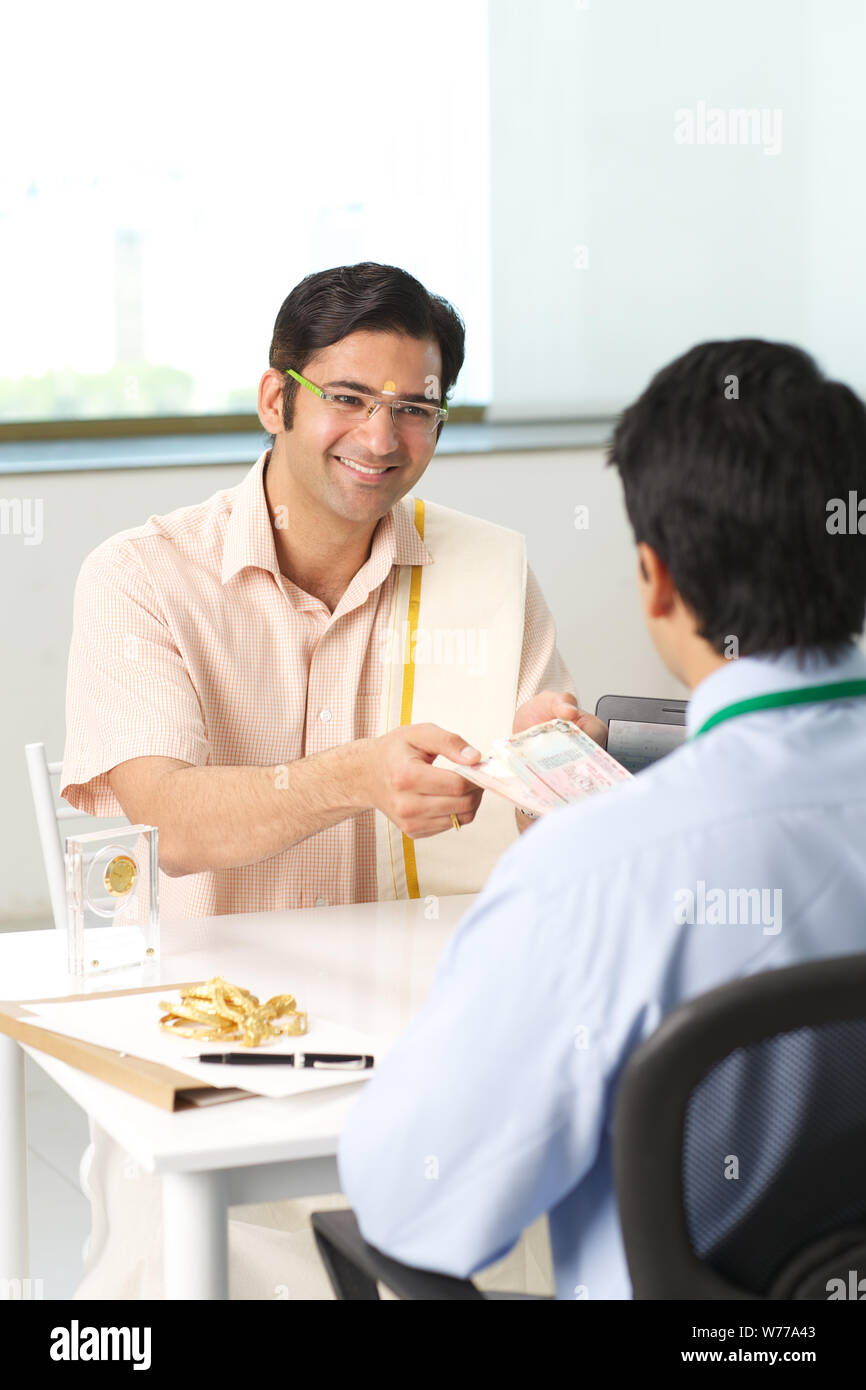 Giving money bank teller hi-res stock photography and images - Alamy