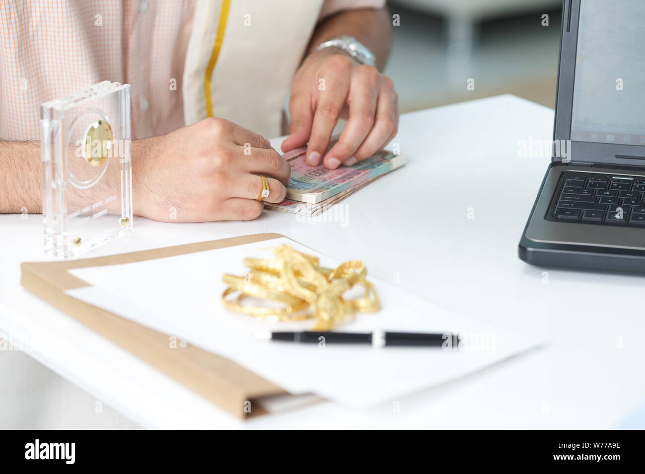 South Indian man counting money of gold loan Stock Photo - Alamy
