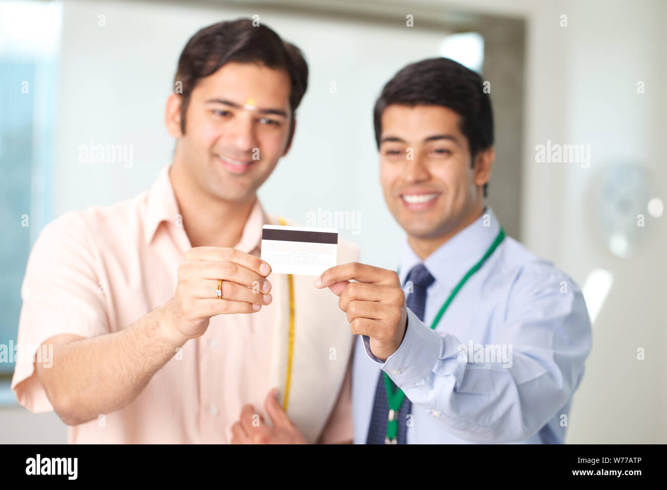 Financial advisor and a South Indian man holding a credit card Stock ...