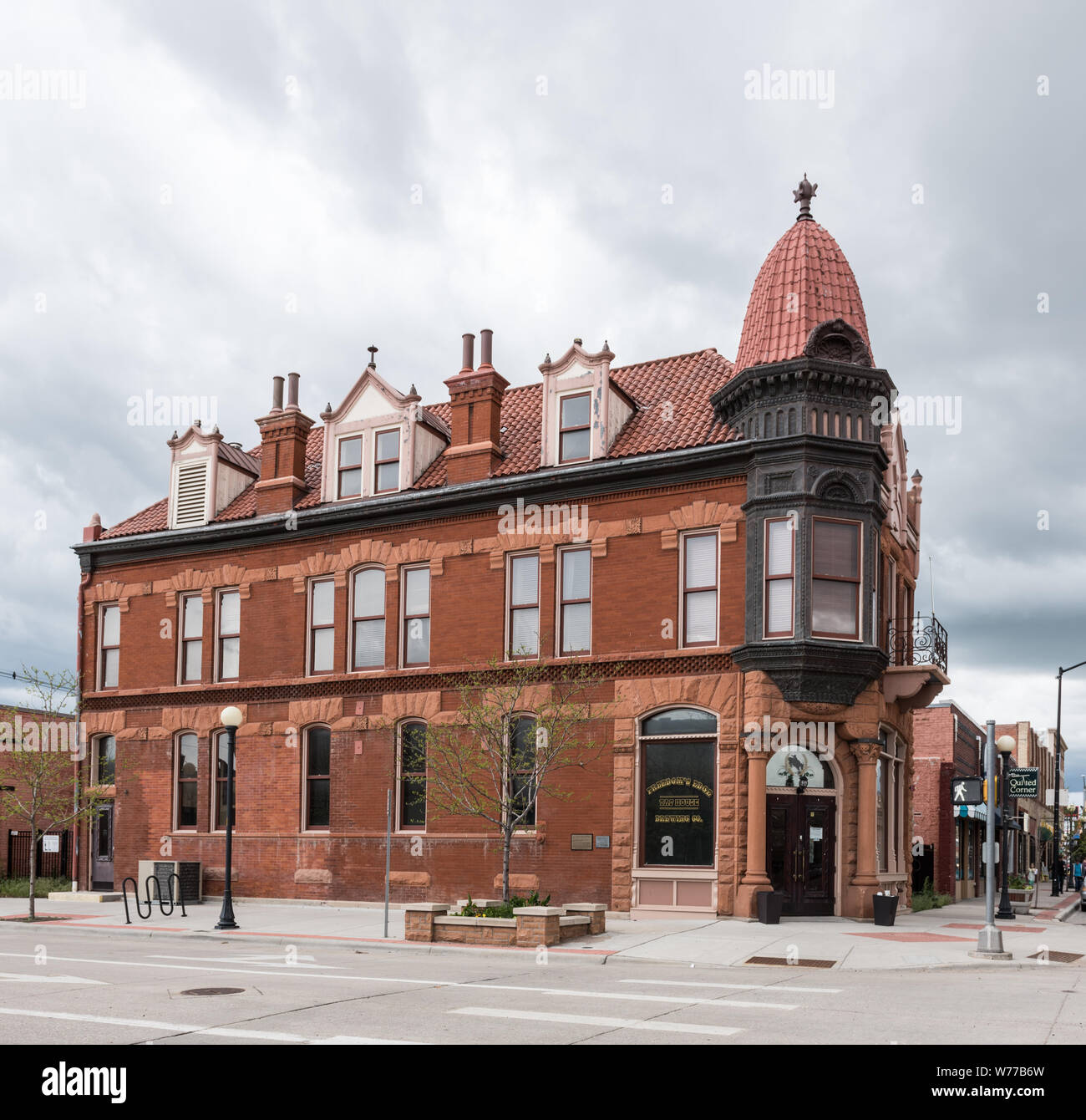 A once-stately stone and brick, turreted commercial building in Wyoming ...