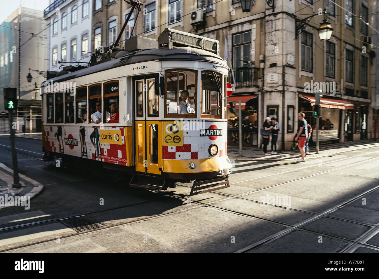 Colorful yellow inner city tram public transport Stock Photo - Alamy