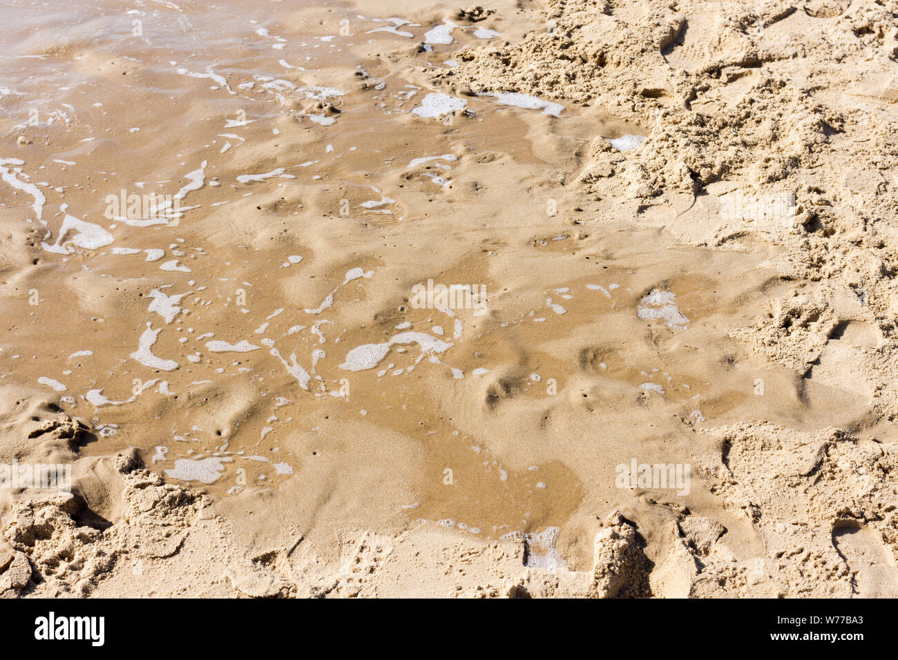 Wet sand on a beach in Bournemouth, Dorset, UK Stock Photo - Alamy