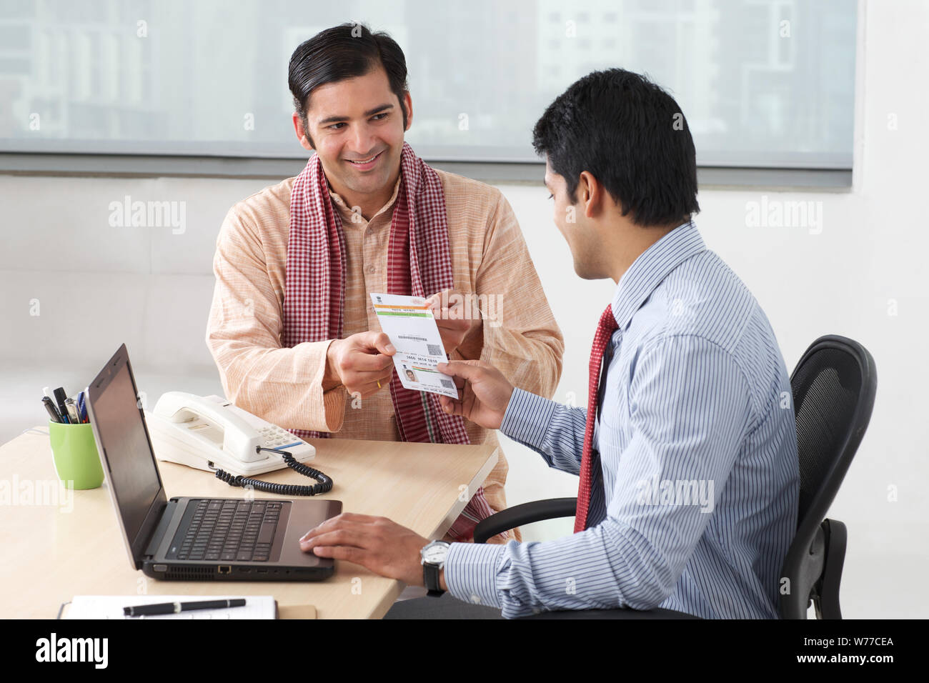 An image of a man holding his id card hi-res stock photography and ...