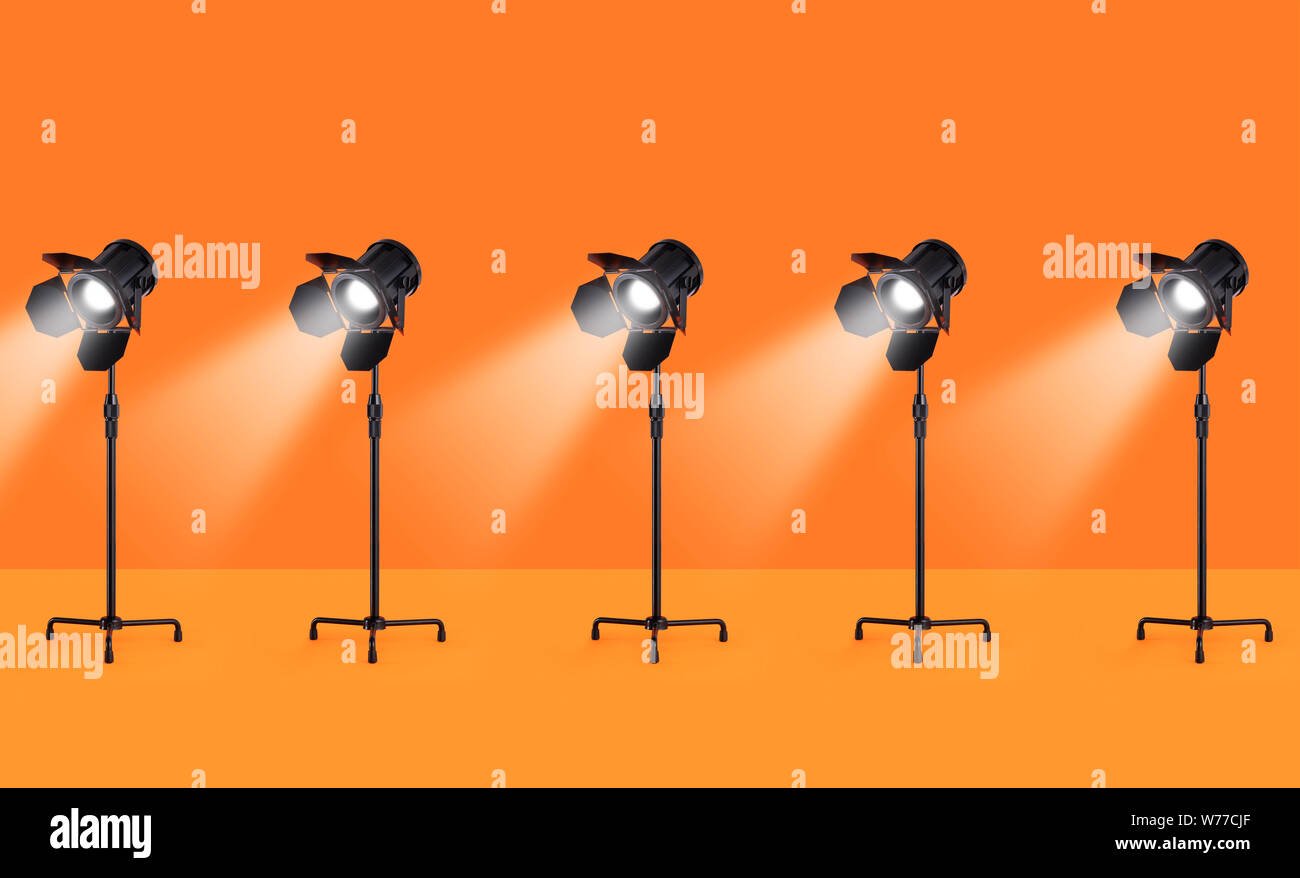 Studio lamps organized in a row over orange background Stock Photo - Alamy