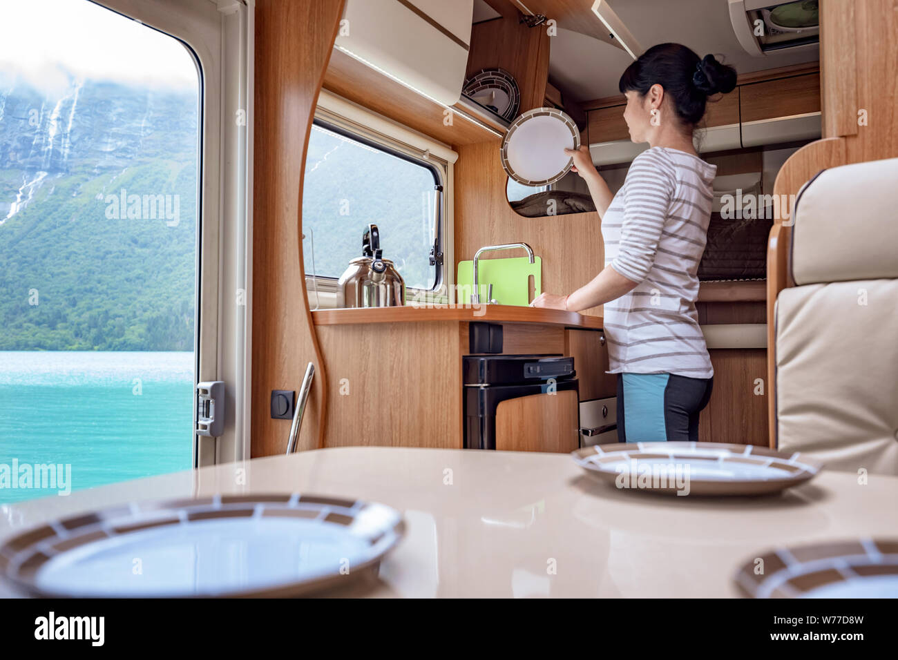 Woman cooking in camper, motorhome RV interior. Family vacation travel ...