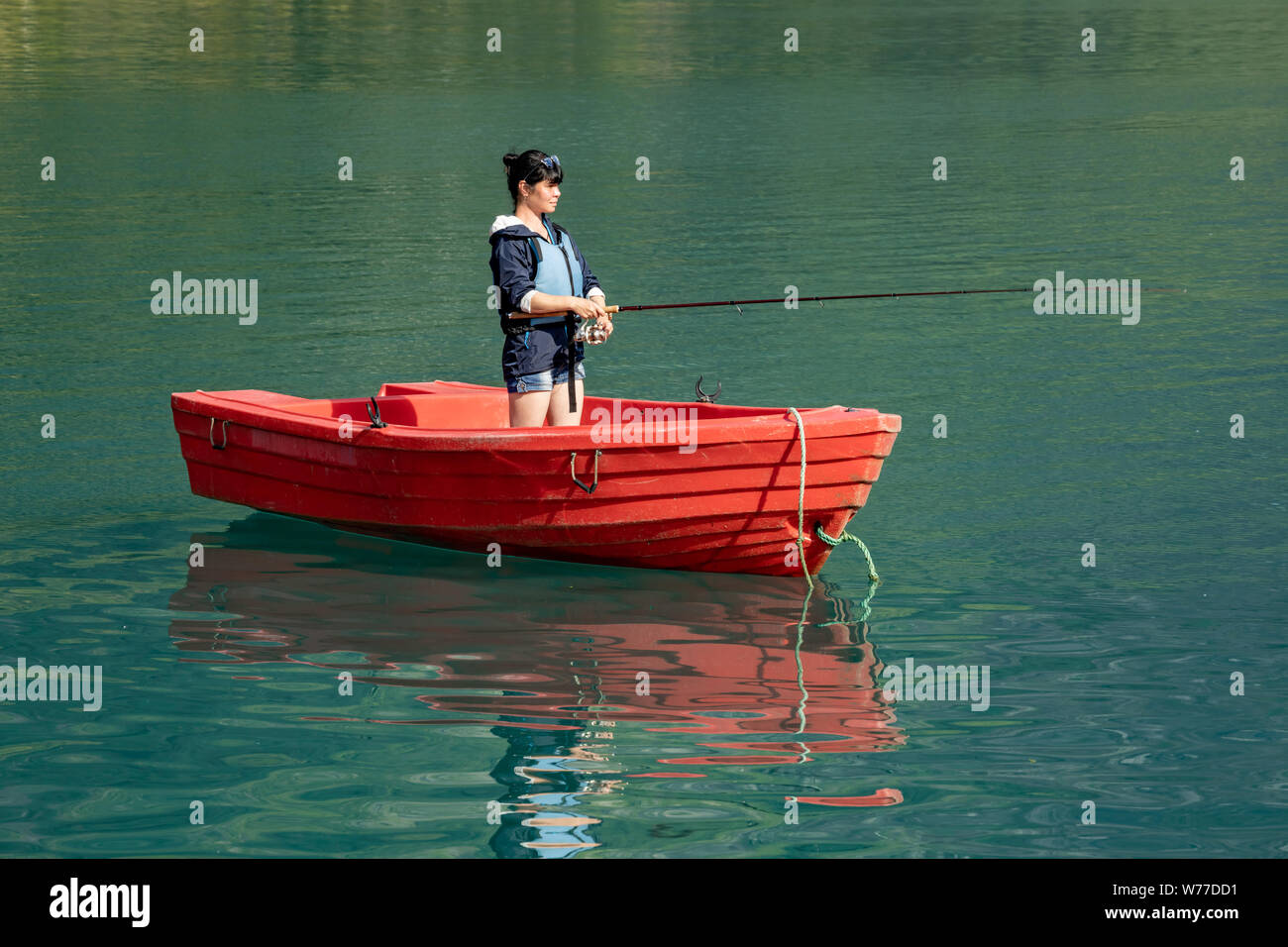 Woman fishing on a boat. Beautiful Nature Norway natural landscape ...