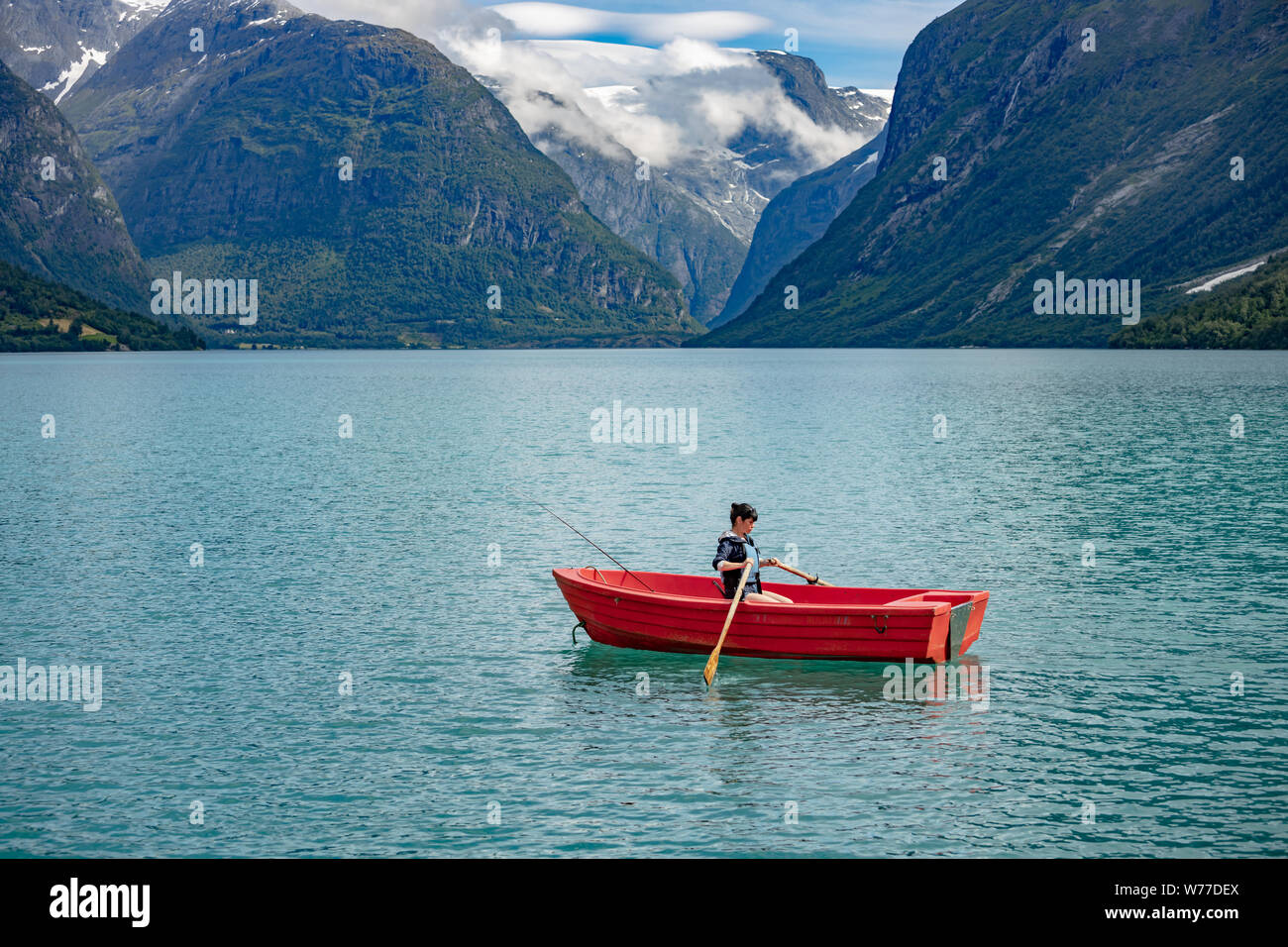 Woman fishing on a boat. Beautiful Nature Norway natural landscape ...