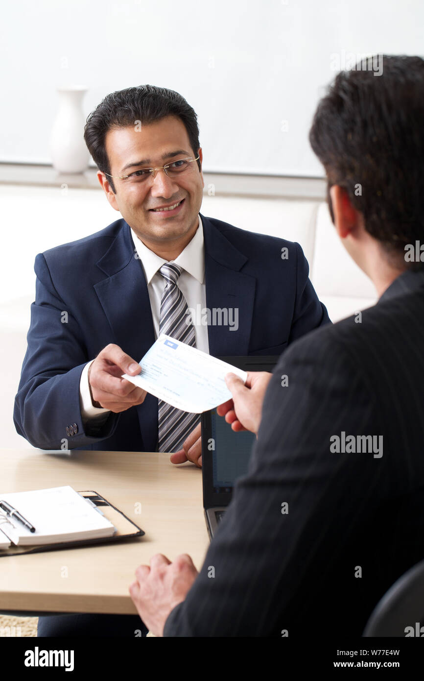 Bank manager giving cheque to his customer as loan Stock Photo - Alamy