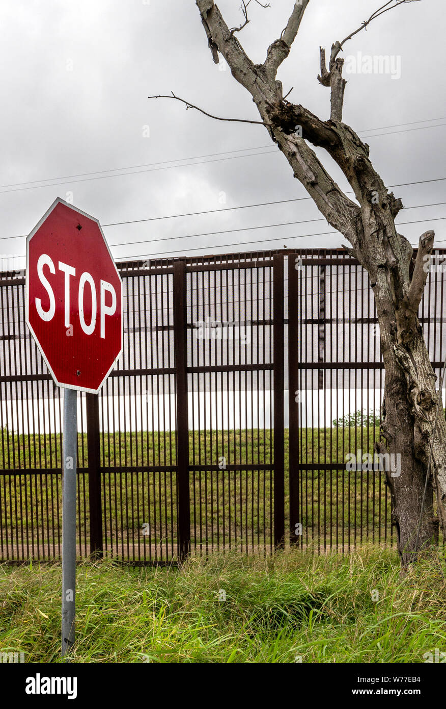 Stop sign in front of the Border wall with Mexico, Brownsville, Texas ...