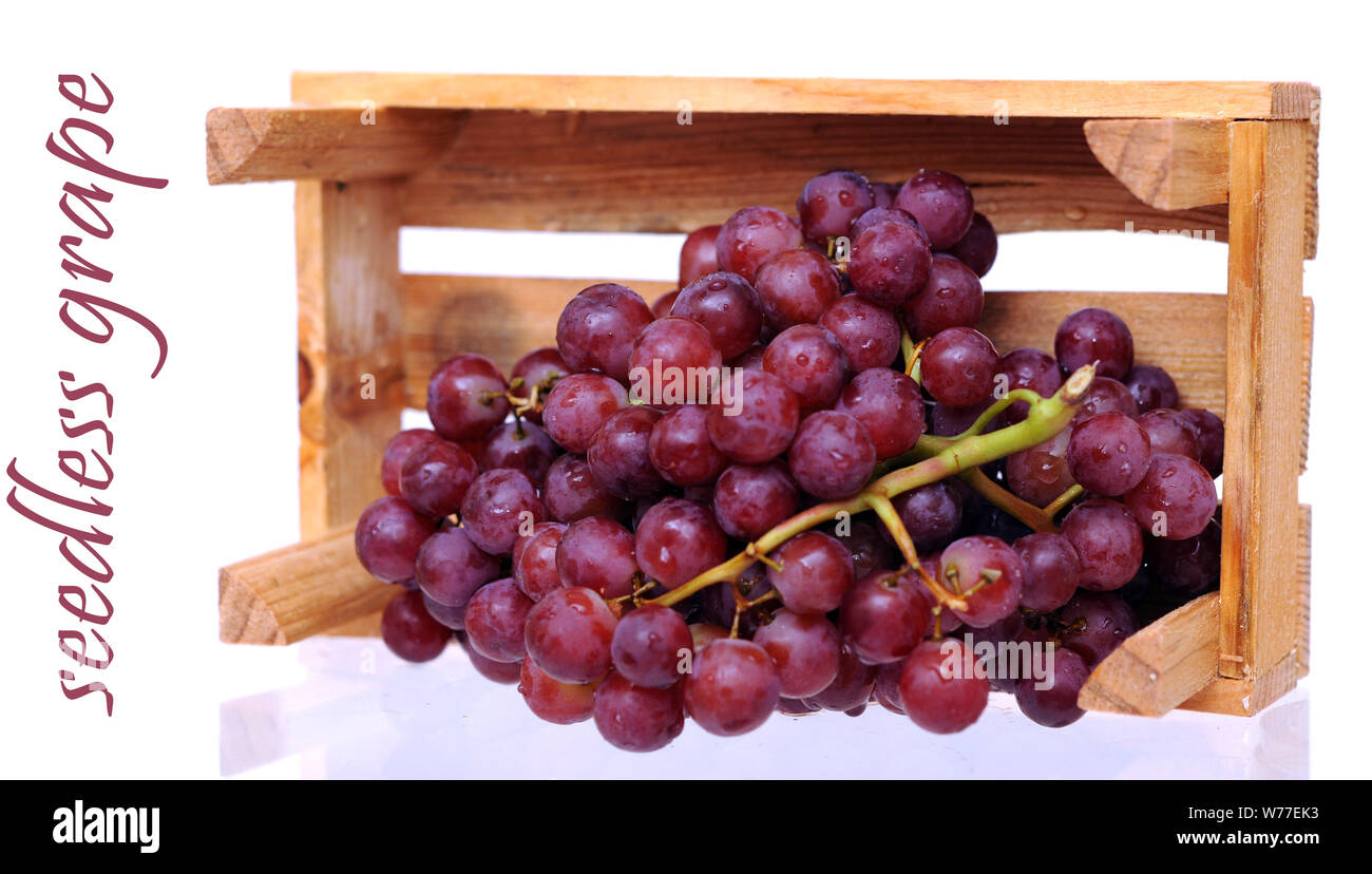 fresh red grapes falling out standing crate isolated on white Stock ...