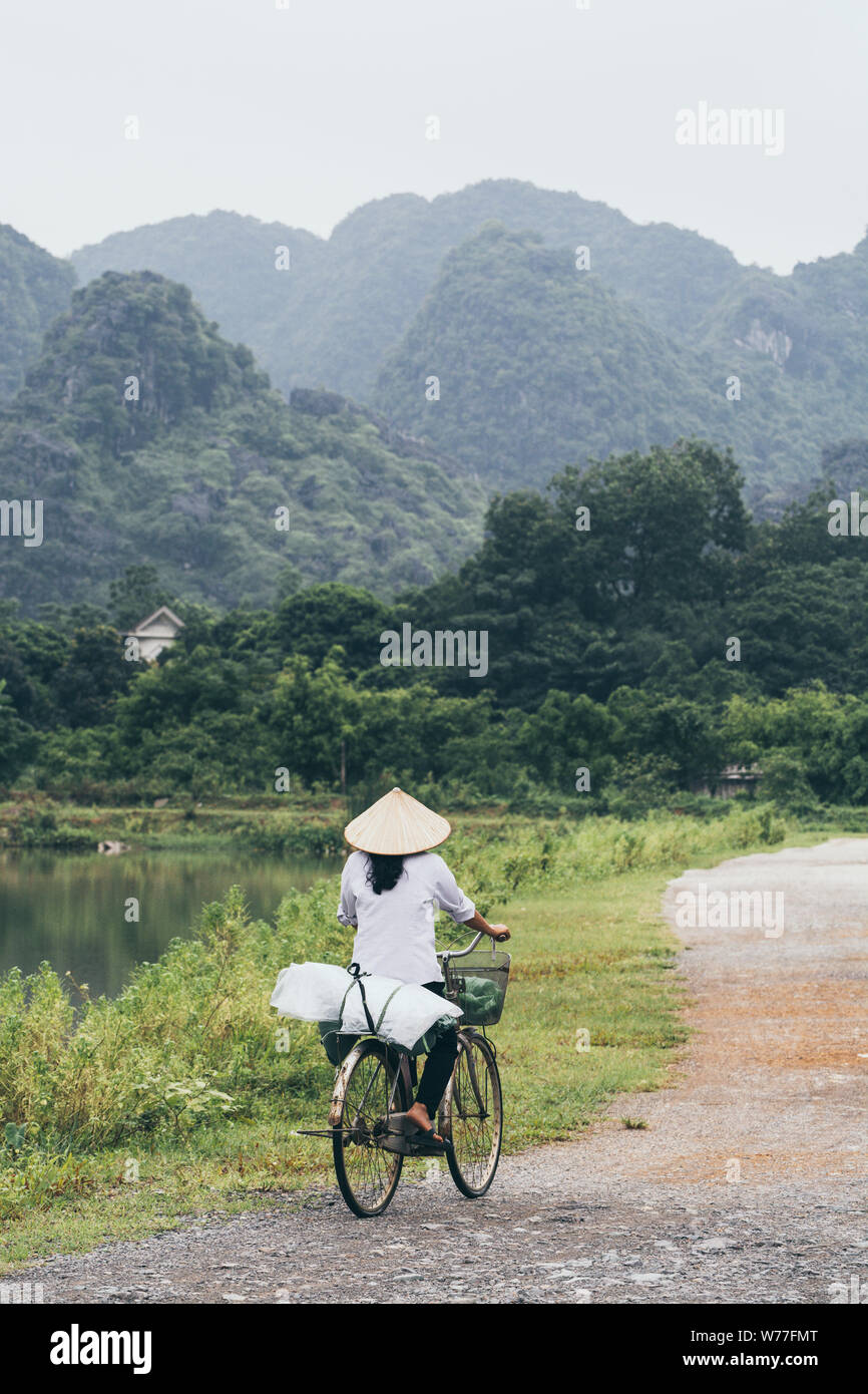 Ninh Binh, Vietnam - May 2019: Vietnamese woman in a rice conical hat ...