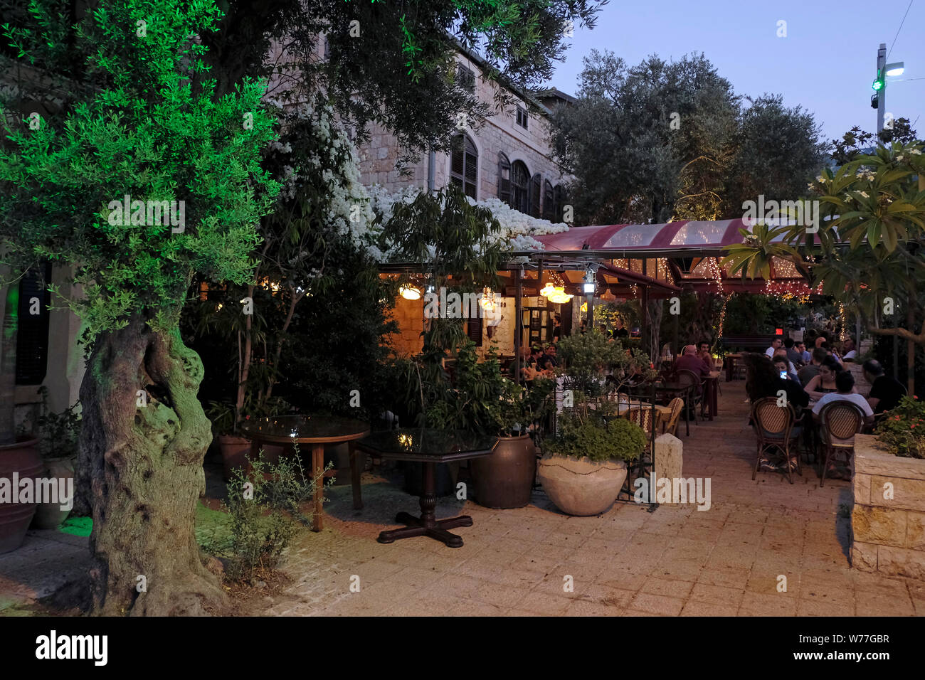 People sit in a cafe located in an old Templer house in the German ...