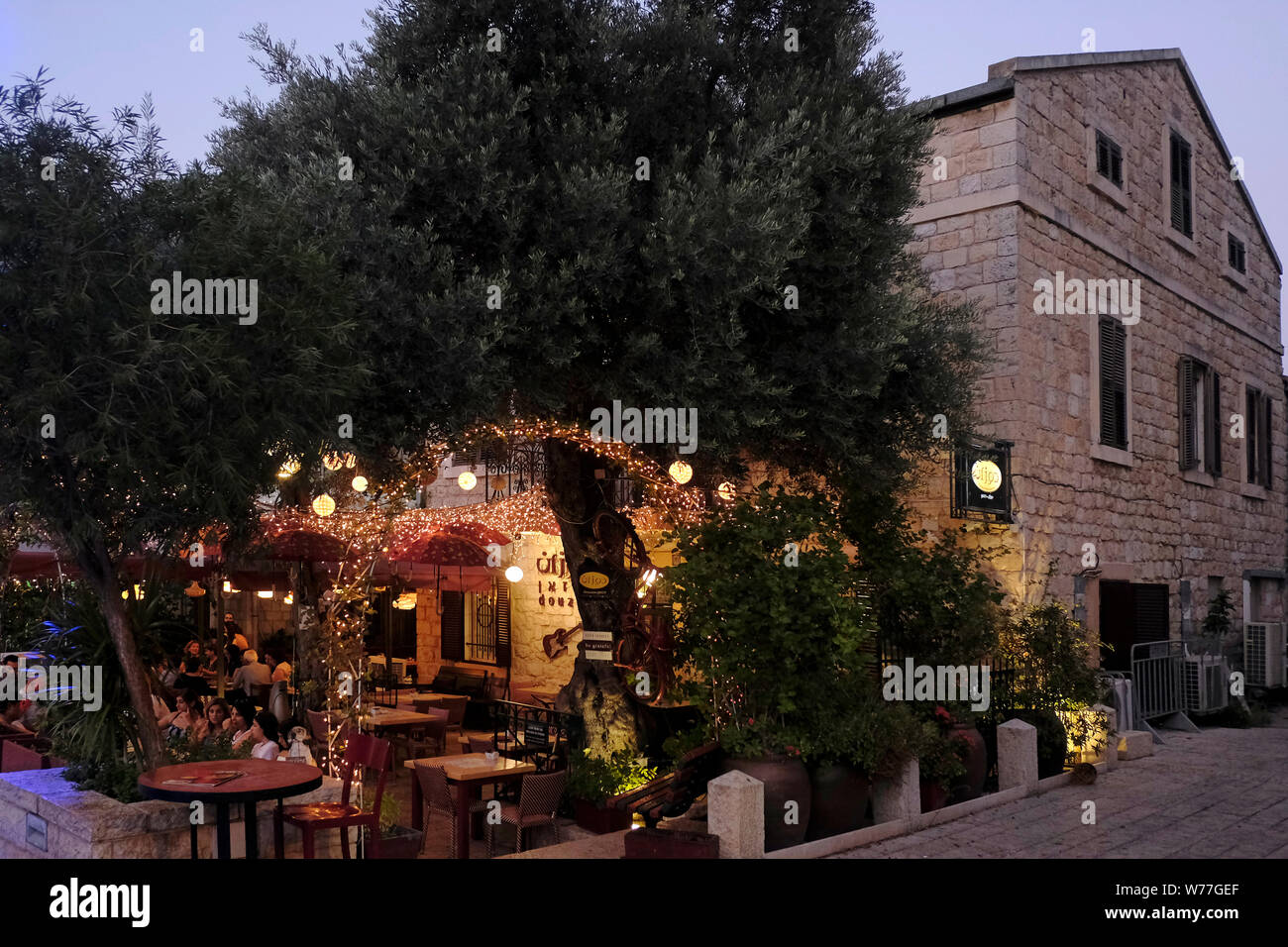 People sit in a cafe located in an old Templer house in the German ...