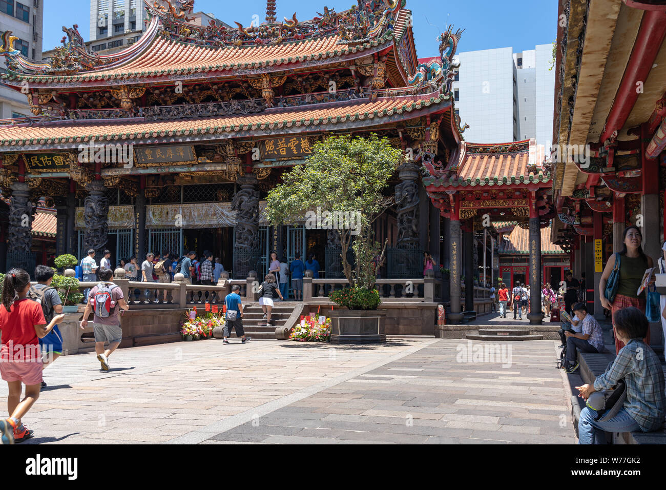 Believers piously worship in the Bangka Longshan Temple. Is a Chinese ...