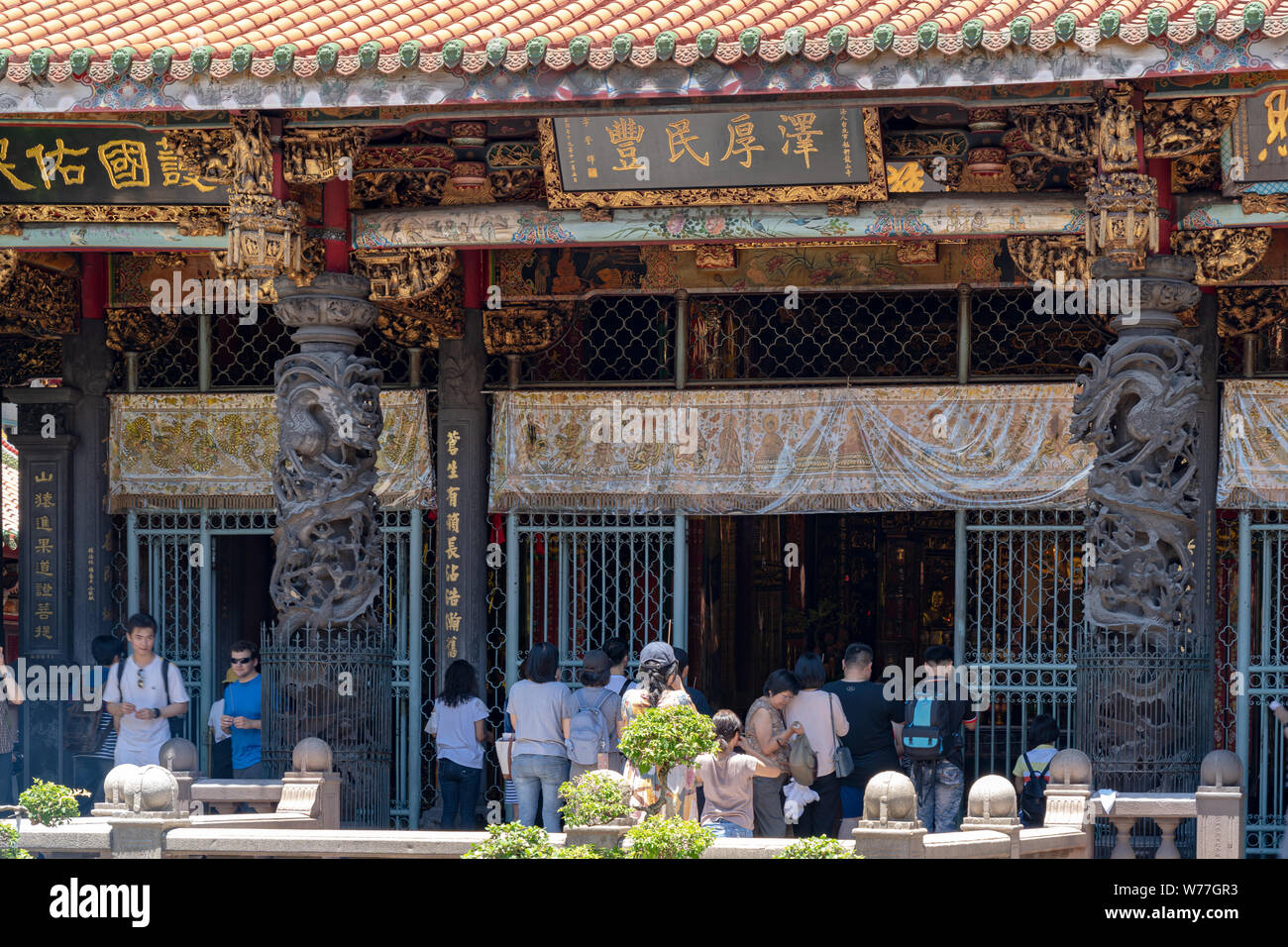 Believers piously worship in the Bangka Longshan Temple. Is a Chinese ...