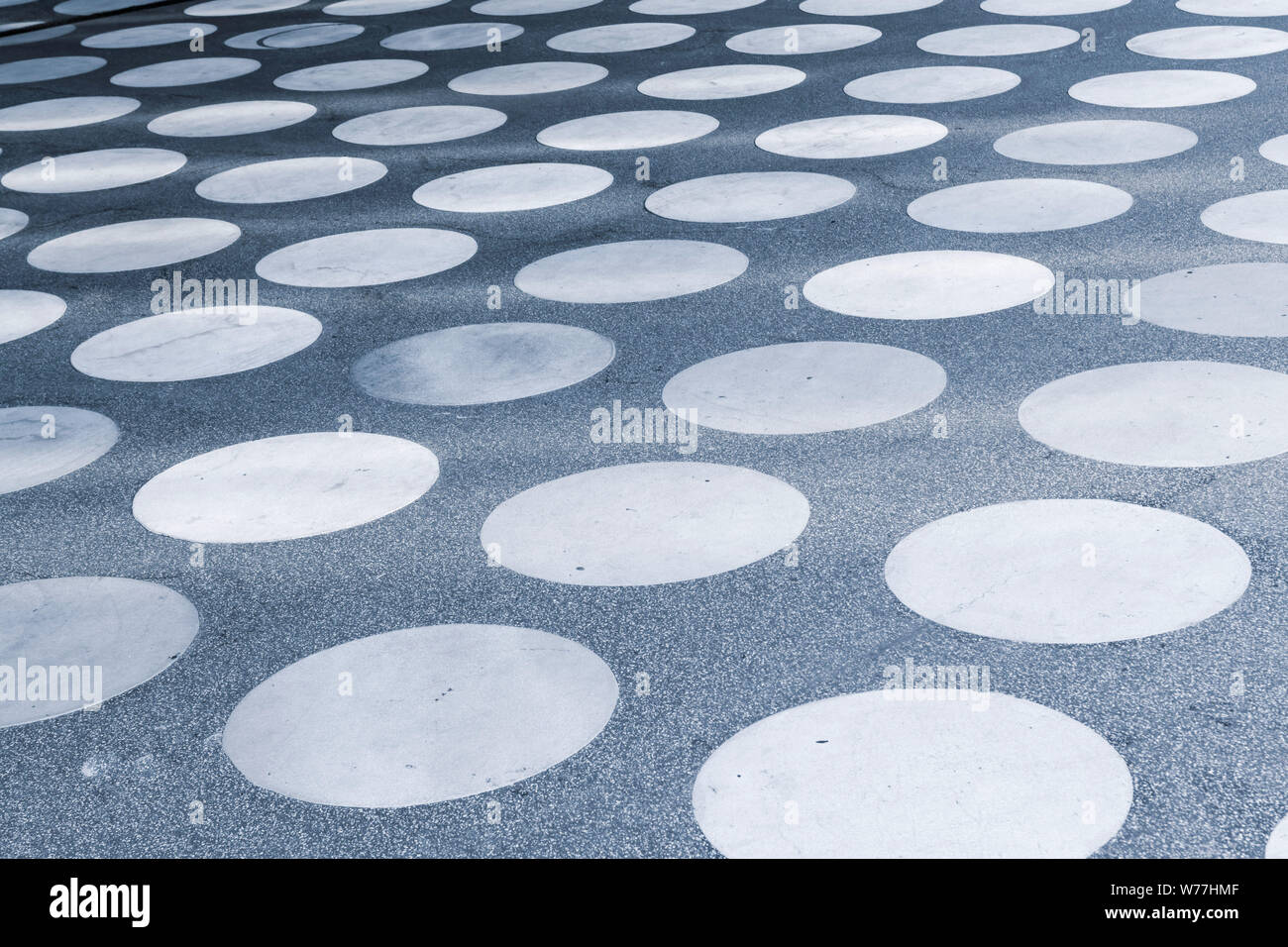 A concrete square with a symmetrical white circle pattern seen in ...
