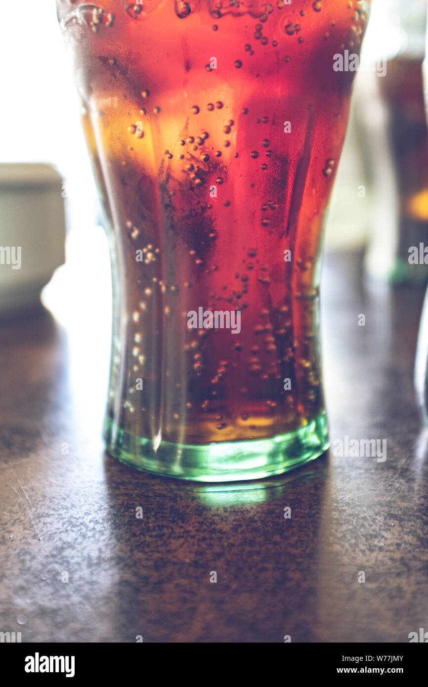 Coke refreshment drink on a drinking glass backlit close up still Stock ...