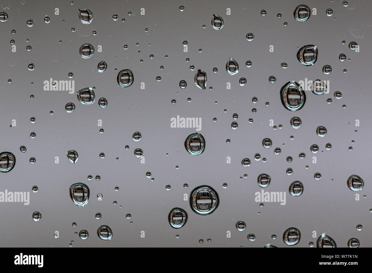 Water drops on a grey glass textured Stock Photo - Alamy