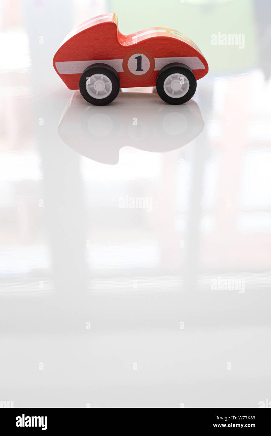 Red toy tiny car on a white background Stock Photo - Alamy