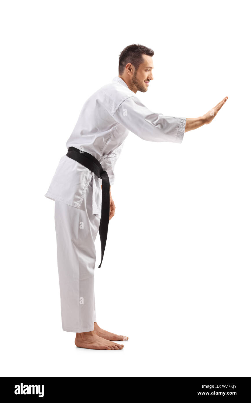 Full length profile shot of a man in karate kimono gesturing with hand ...