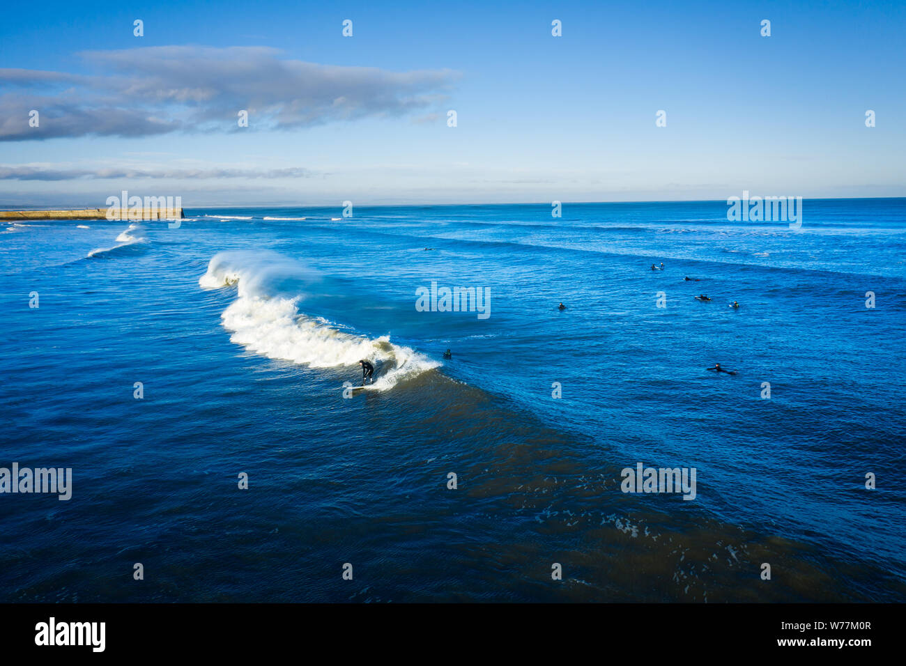 Surfers on East Sands Beach. Brave surfers suffer the brutally cold ...