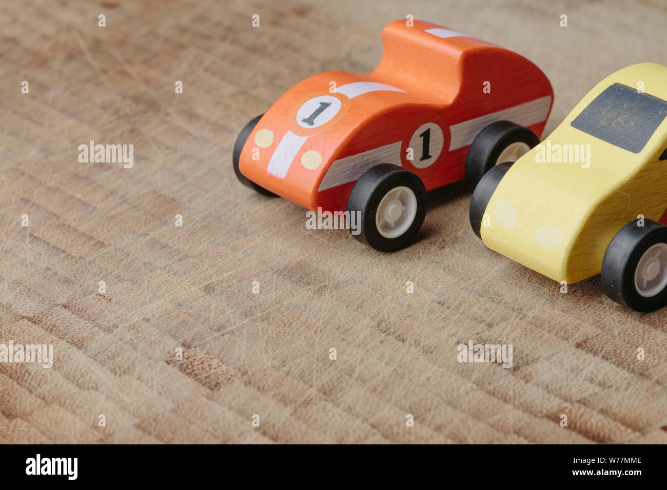 Vintage red and yellow toy car on a wooden surface Stock Photo - Alamy