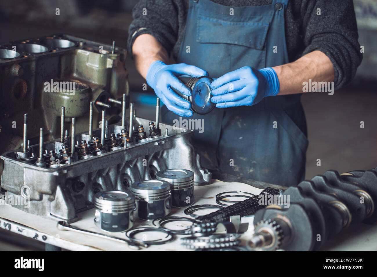 Master collects a rebuilt motor for the car Stock Photo - Alamy